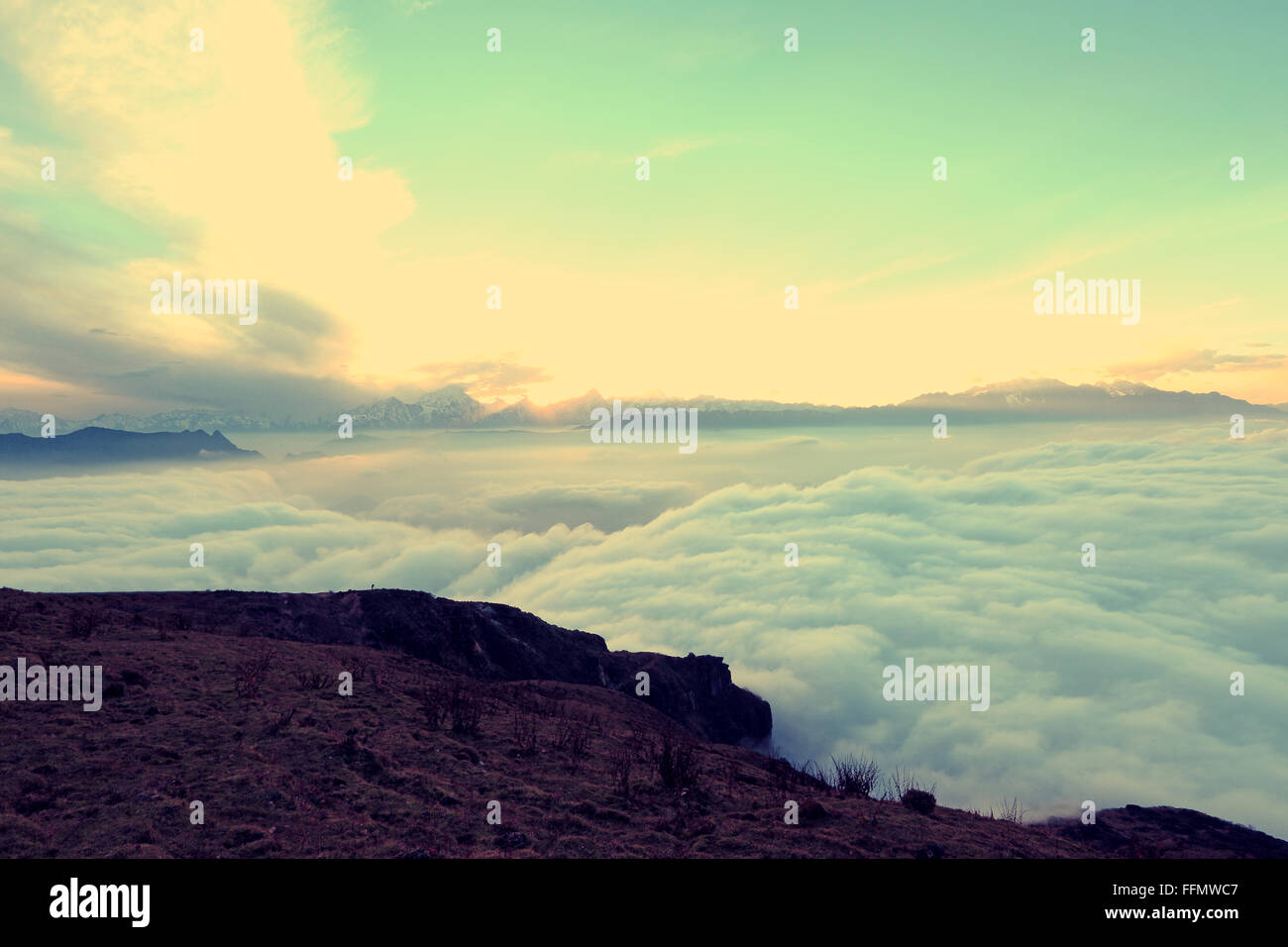 beautiful rolling clouds and sunrise on frozen mountain summits ...