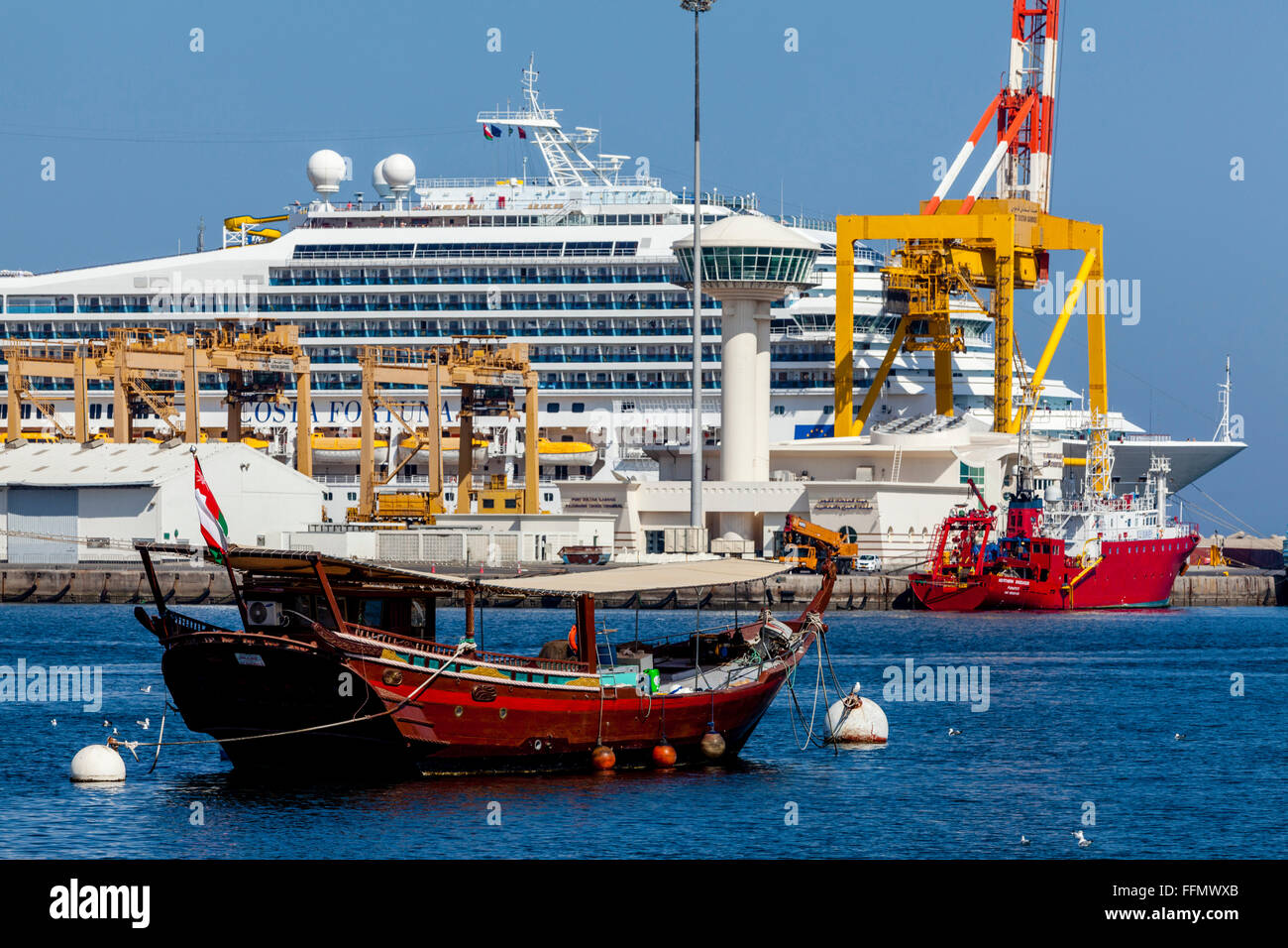 A Traditional Dhow InThe Harbour At Muttrah With Modern Cruise Ships in ...