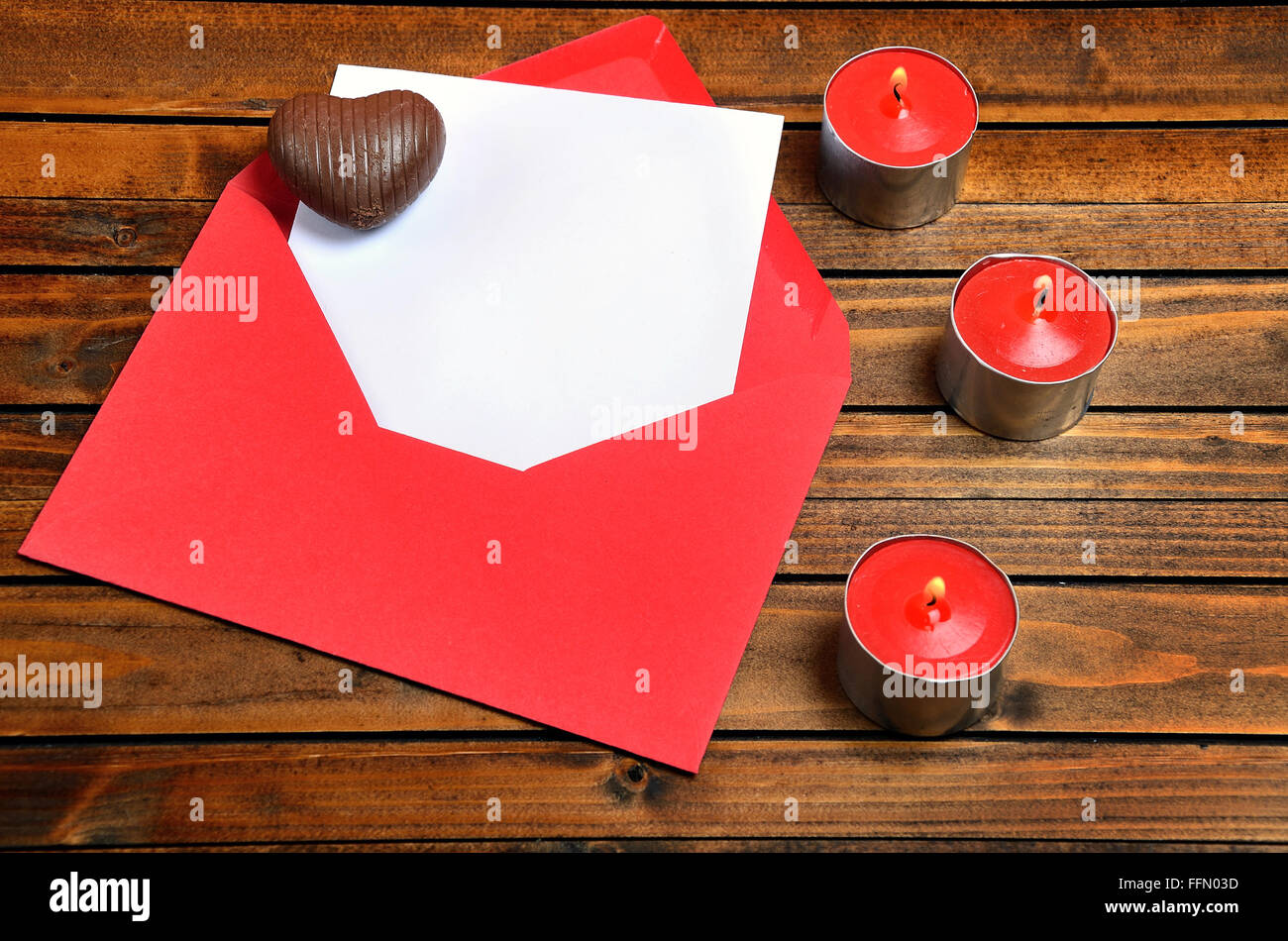 Red envelope with empty paper and candle Stock Photo - Alamy