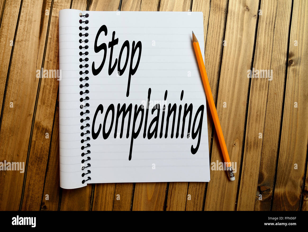 Stop complaining word on notepad Stock Photo - Alamy