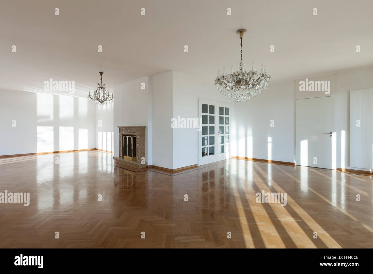 interior of an house, empty big room with fireplace, parquet floor and ...