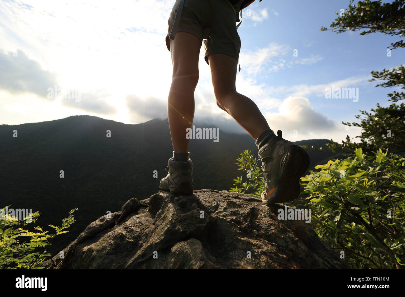 young hiker legs hiking on mountain peak Stock Photo - Alamy