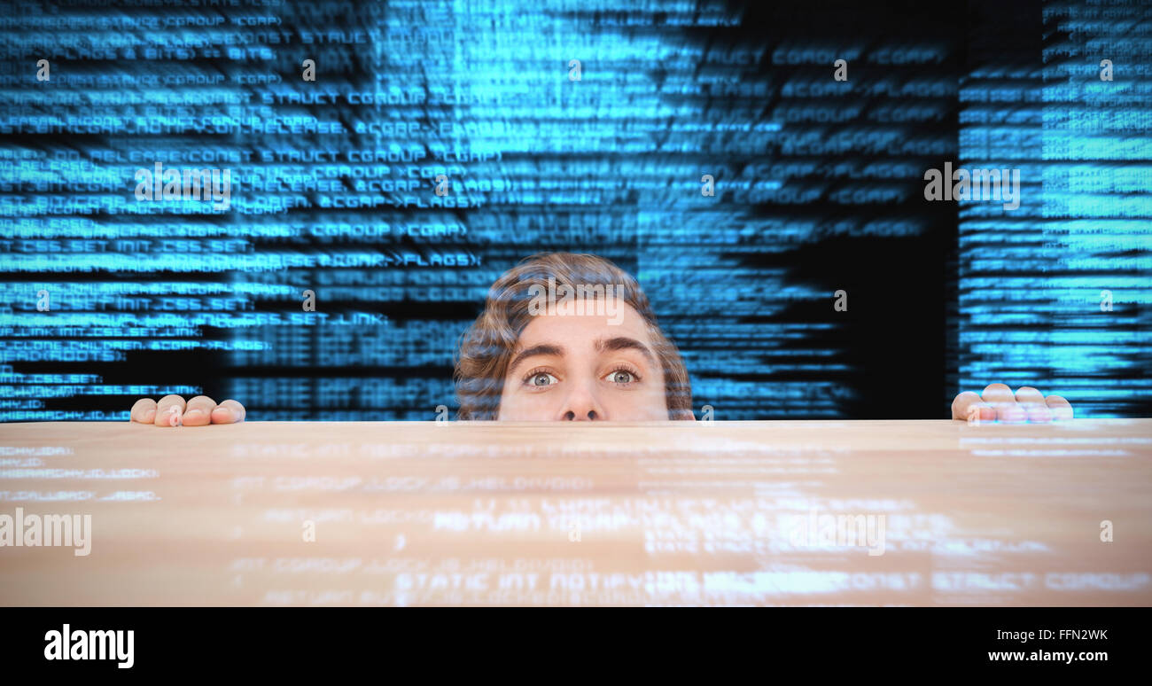 Composite image of man hiding behind desk against white background ...