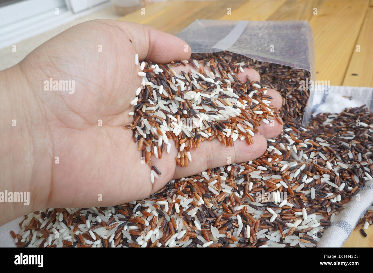 human hand on long grain rice Stock Photo - Alamy