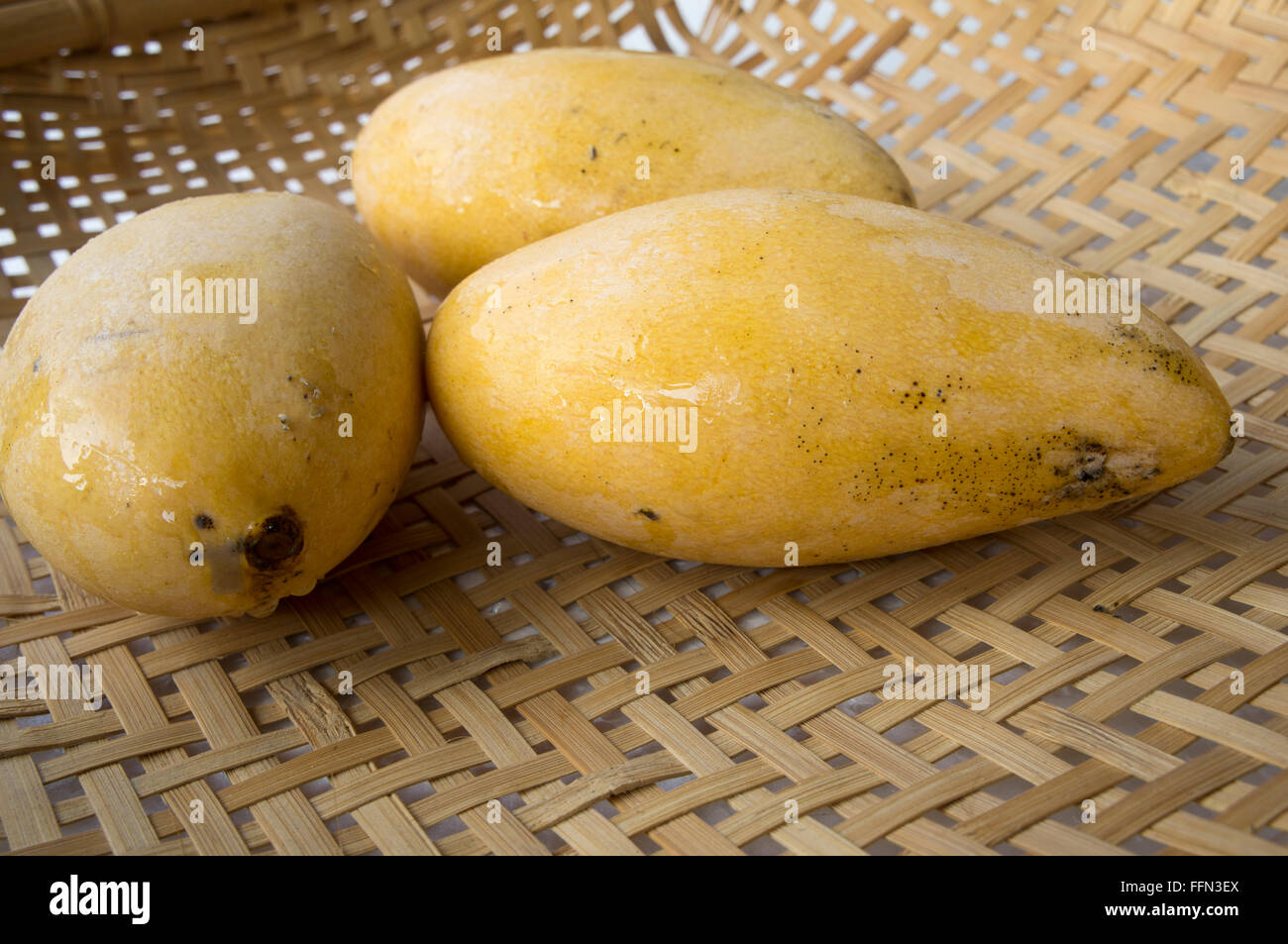 three mangoes on bamboo tray Stock Photo - Alamy