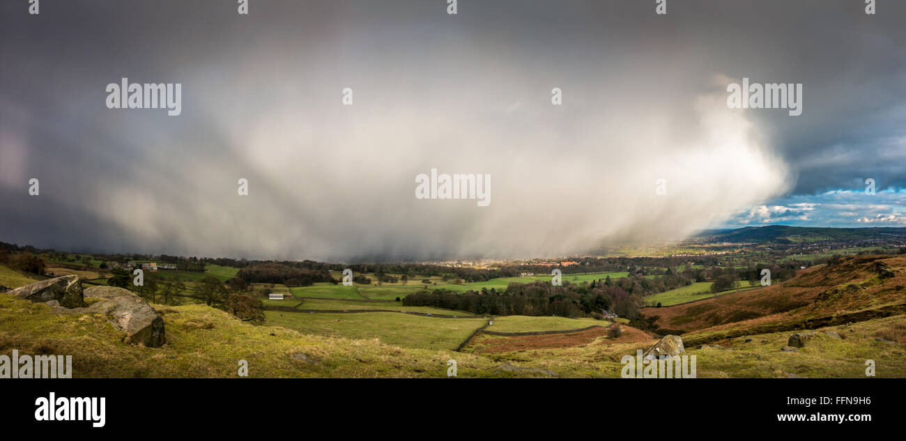 Snow storm hitting the rural Wharfedale valley with the sun's rays ...