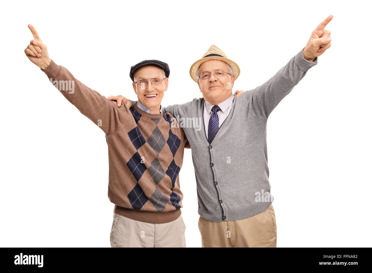 Studio shot of two old friends celebrating together and pointing up ...