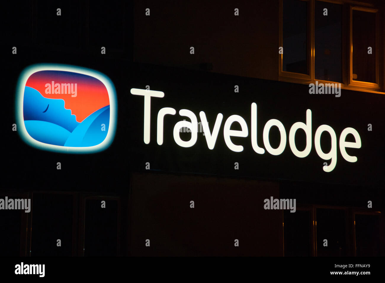 Sign at night outside and on a Travelodge hotel at Oxford Wheatley ...