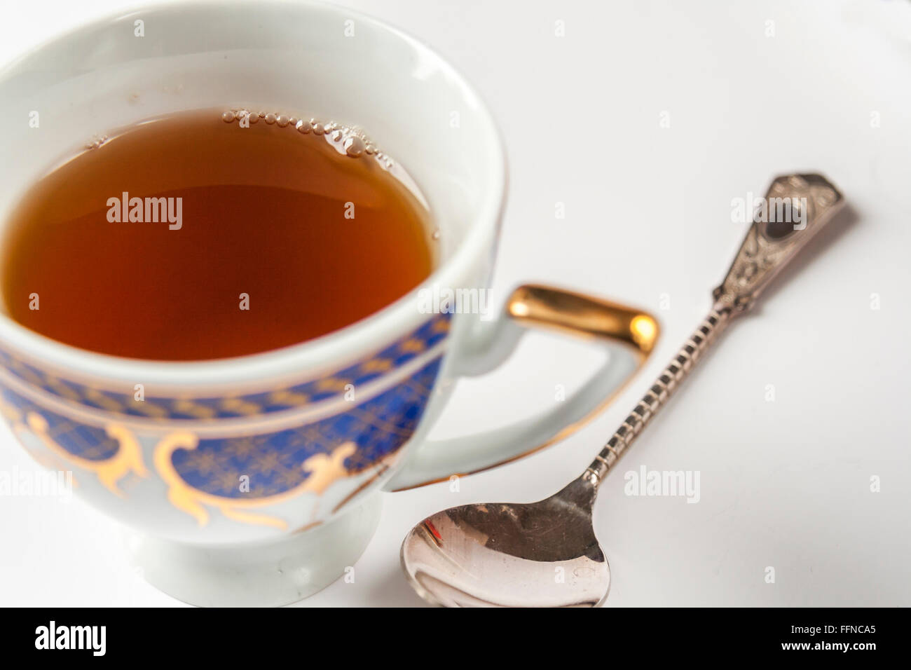 Cup of Black Tea and Spoon Stock Photo - Alamy