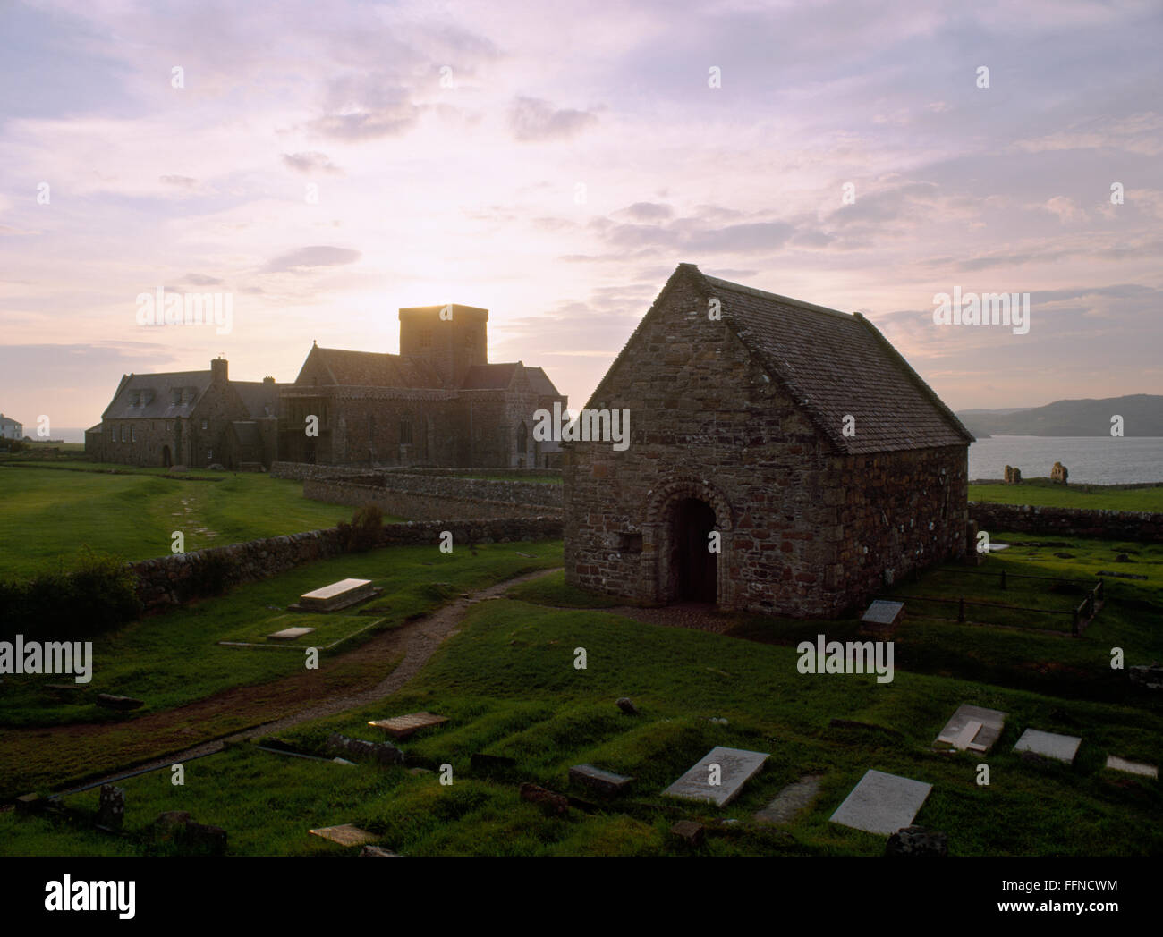 Sunrise above Iona Abbey church tower, C12th St Oran's Chapel & Reilig ...
