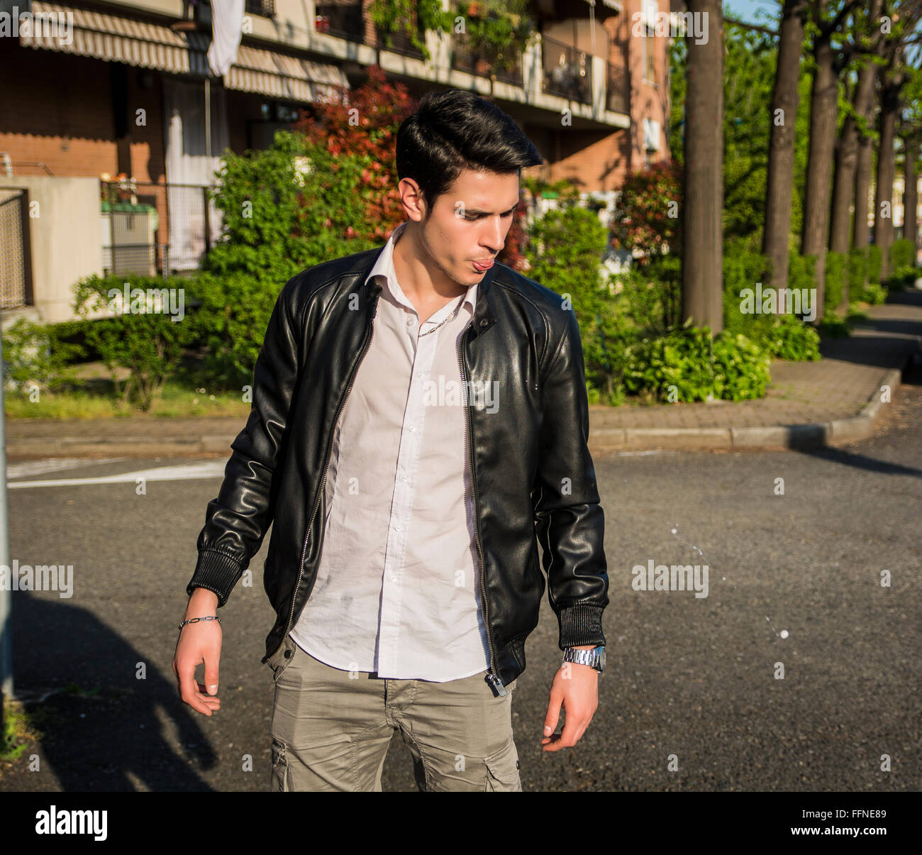 Young man spitting on the street. Summertime Stock Photo - Alamy