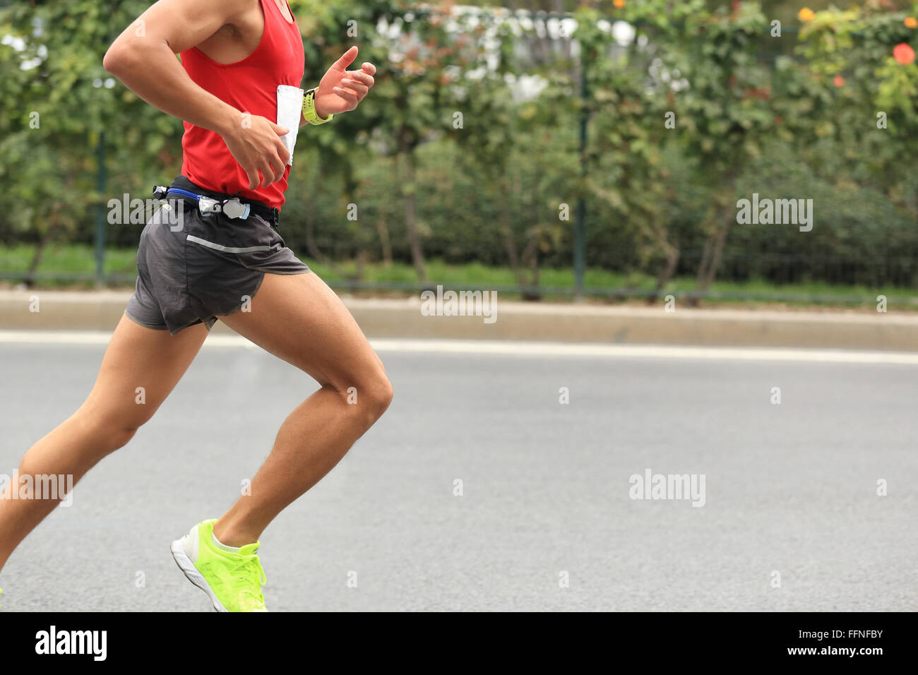 Marathon runner running on city road Stock Photo - Alamy