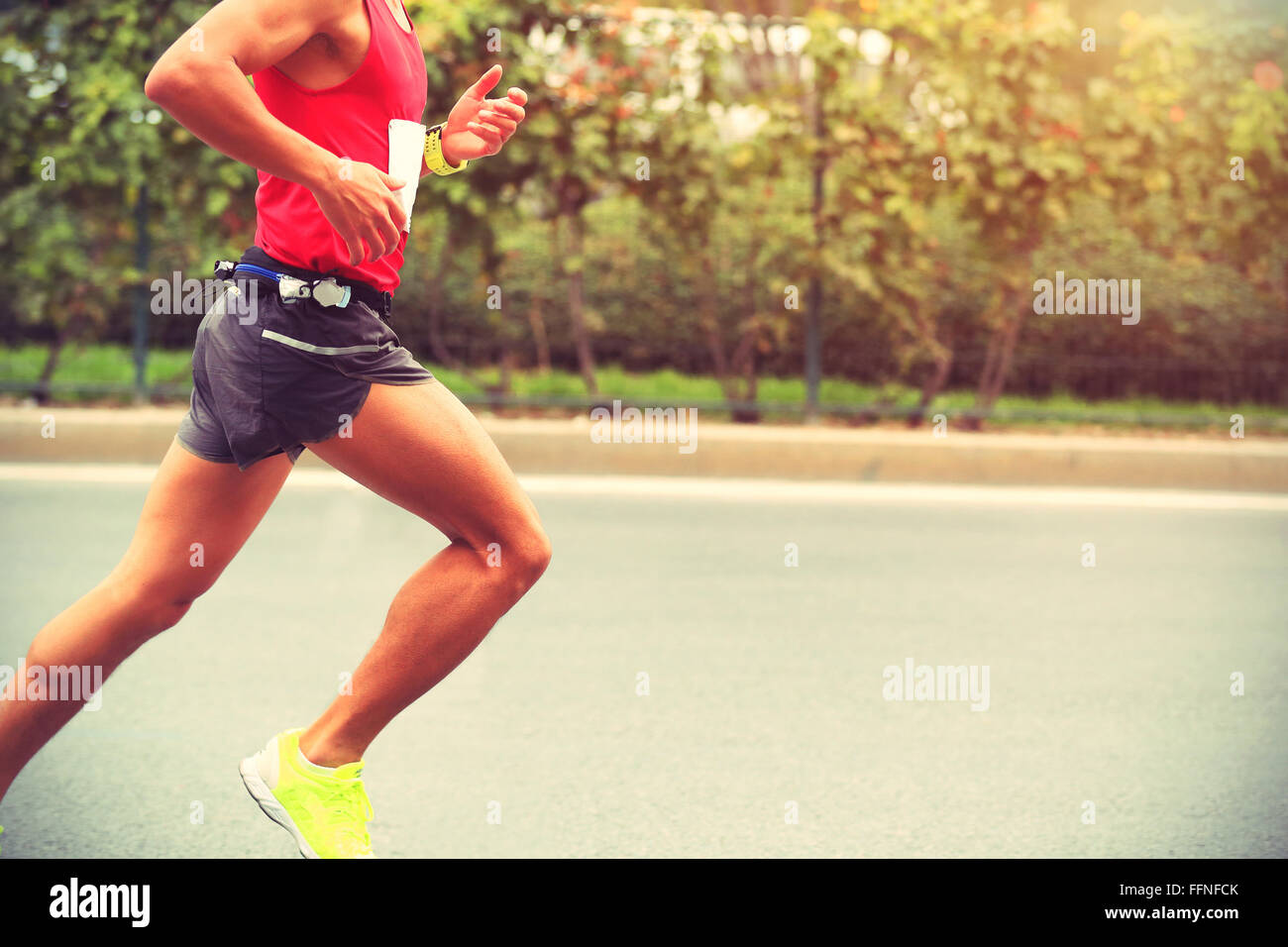 Marathon runner running on city road Stock Photo - Alamy