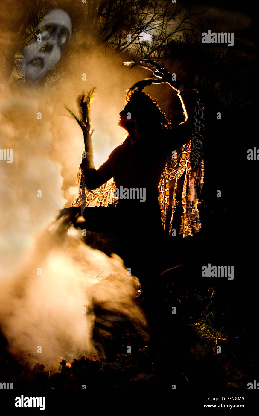 Silhouetted shaman summoning spirit at nighttime Stock Photo - Alamy