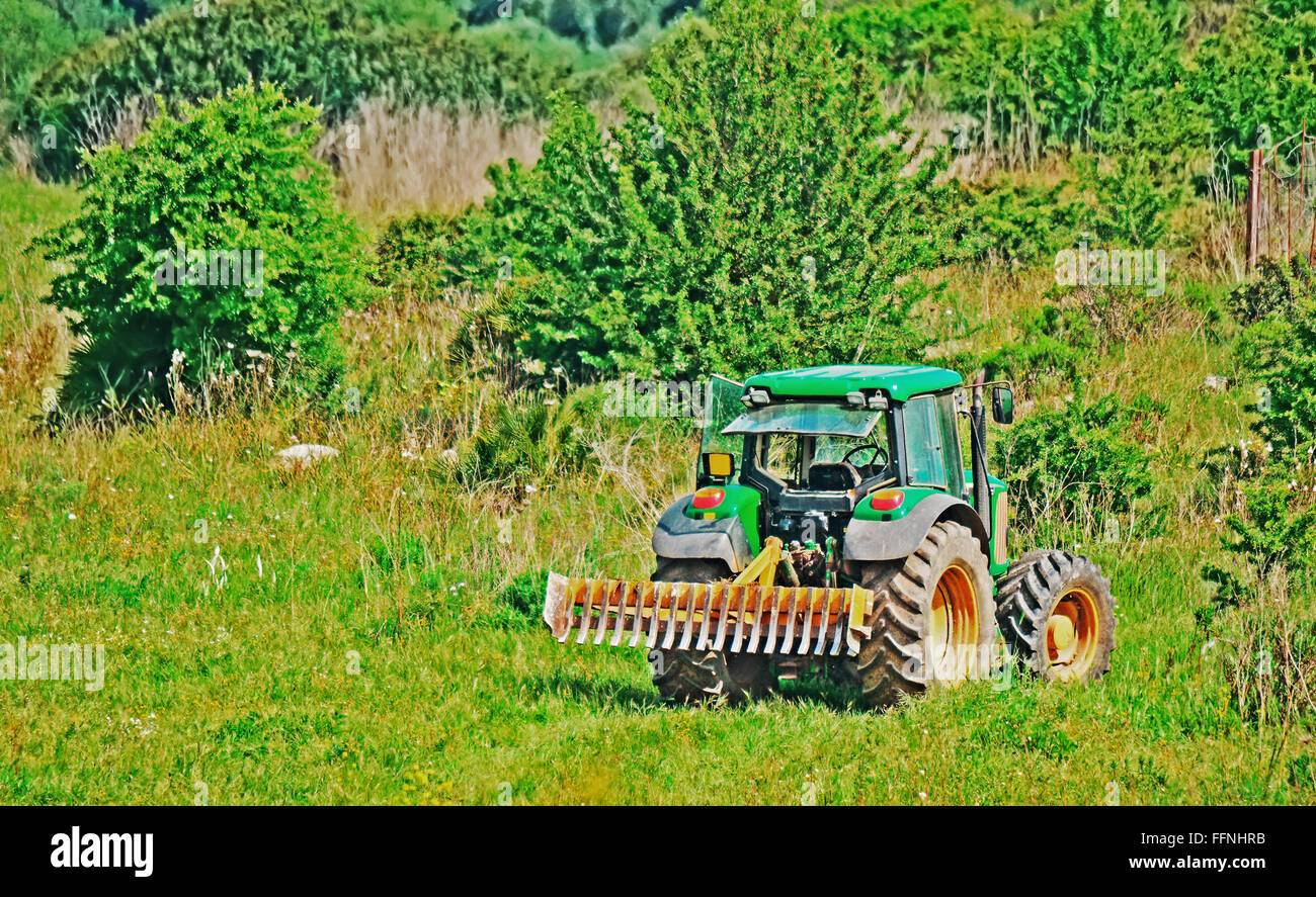green tractor in a green field Stock Photo - Alamy