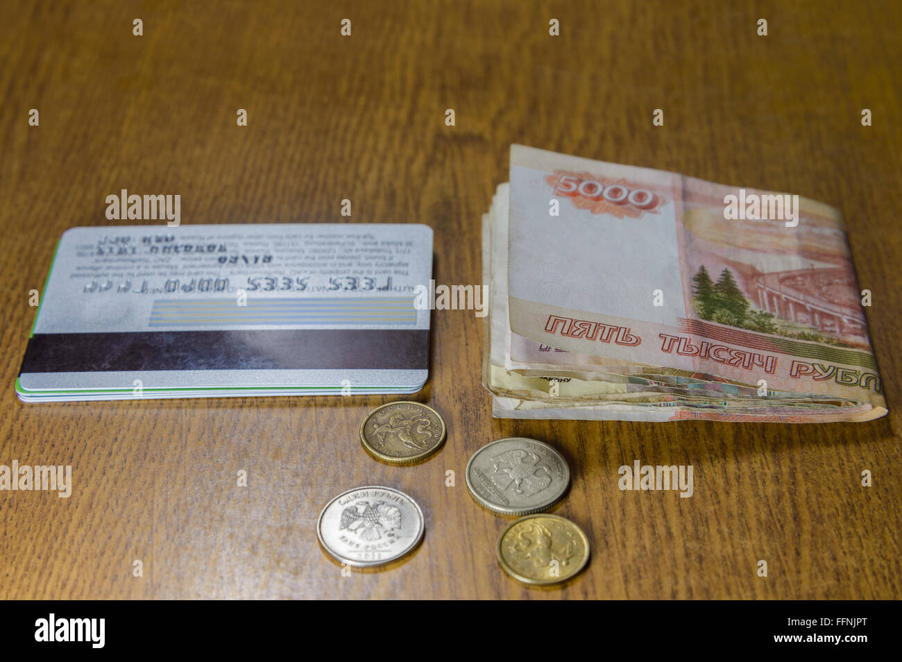 Credit cards and cash lying on a wooden table Stock Photo - Alamy
