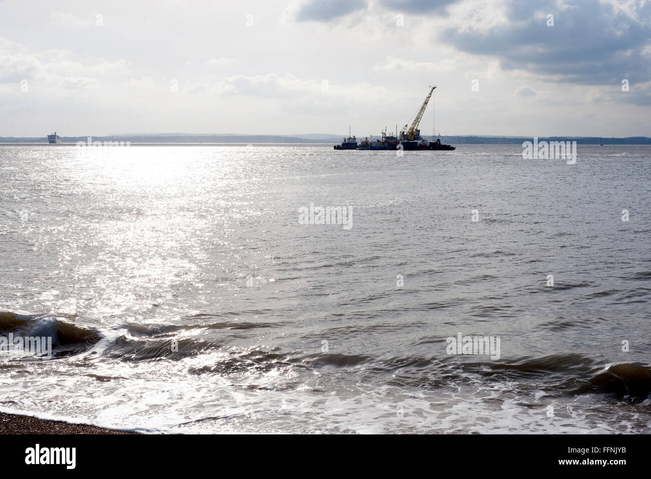 distant view of a dredger dredging the solent seabed between southsea ...