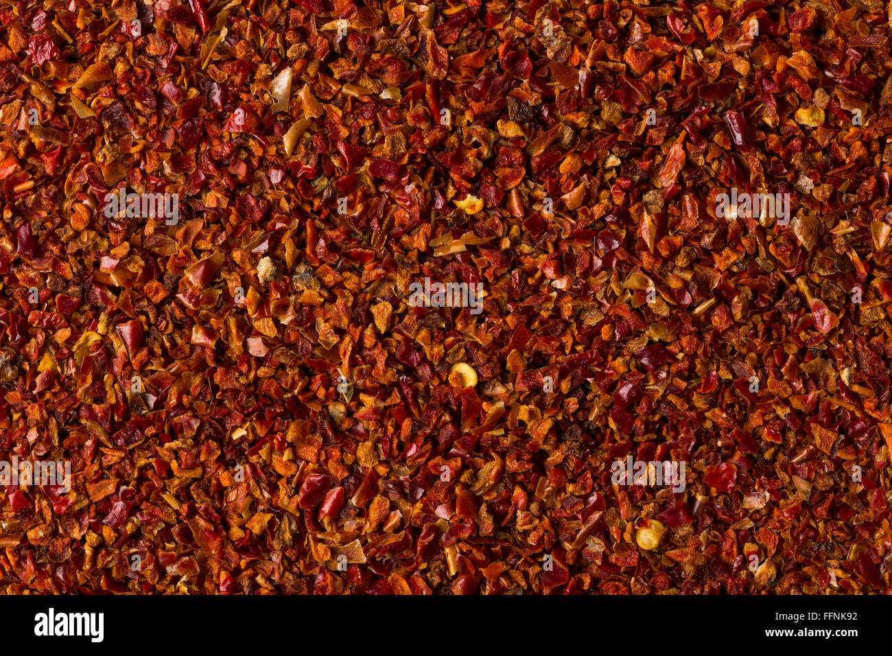 Crushed red chili pepper for background texture Stock Photo - Alamy