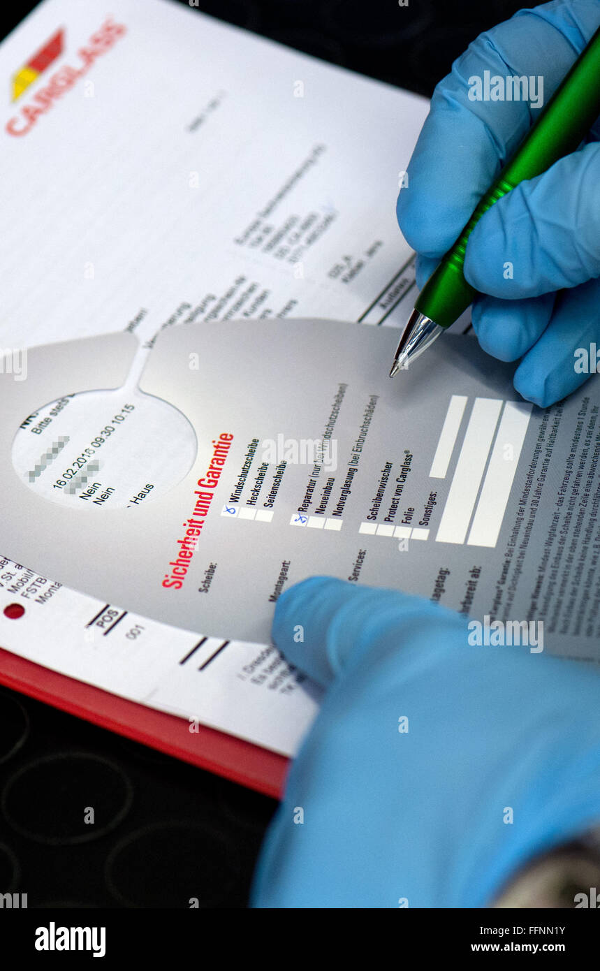 Dresden, Germany. 16th Feb, 2016. A Carglass employee fills out a form ...