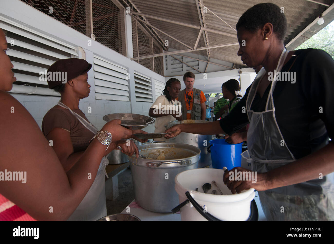 A WFP staff member supervise local people cooking in a kitchen set up ...