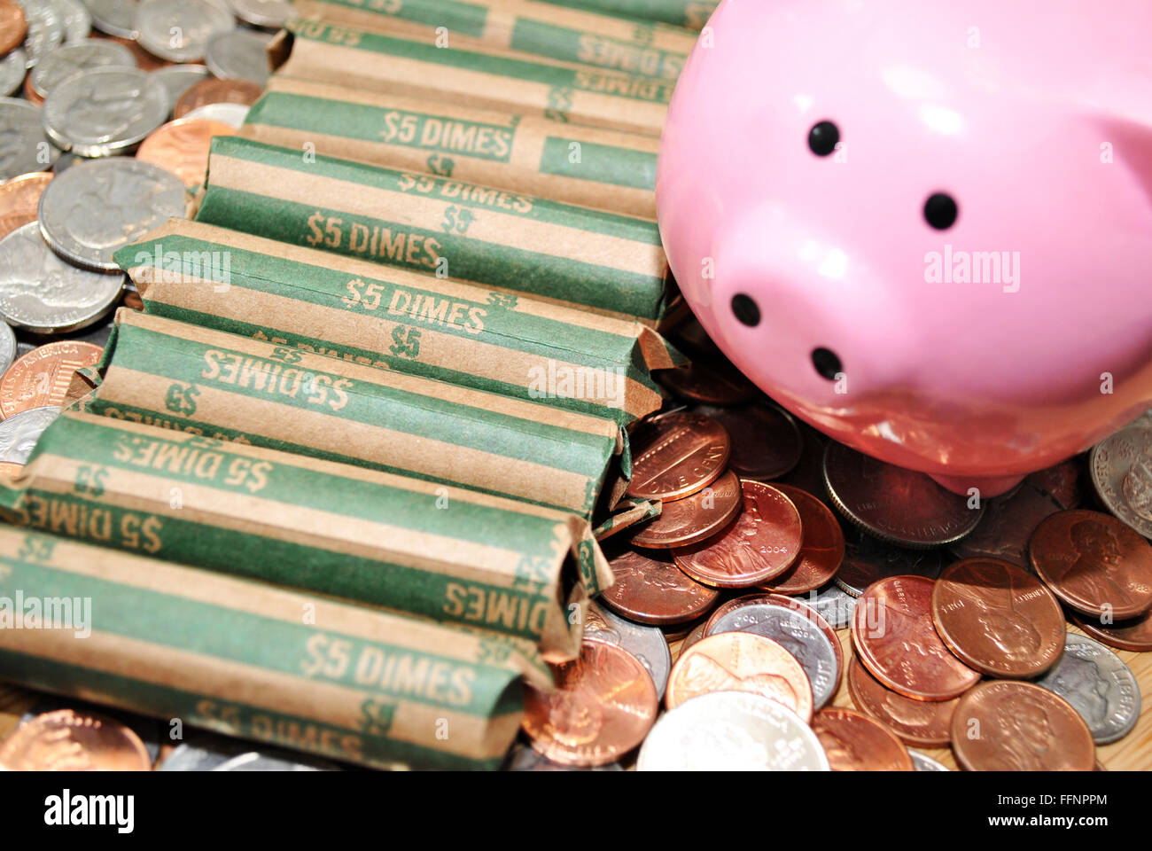 Rolled American Bank Dimes with a Piggy Bank Stock Photo - Alamy
