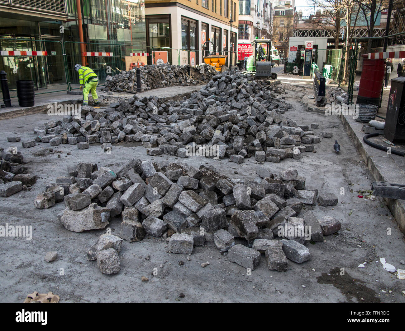 Laying cobbles and stones on a road in Soho, central London Stock Photo ...
