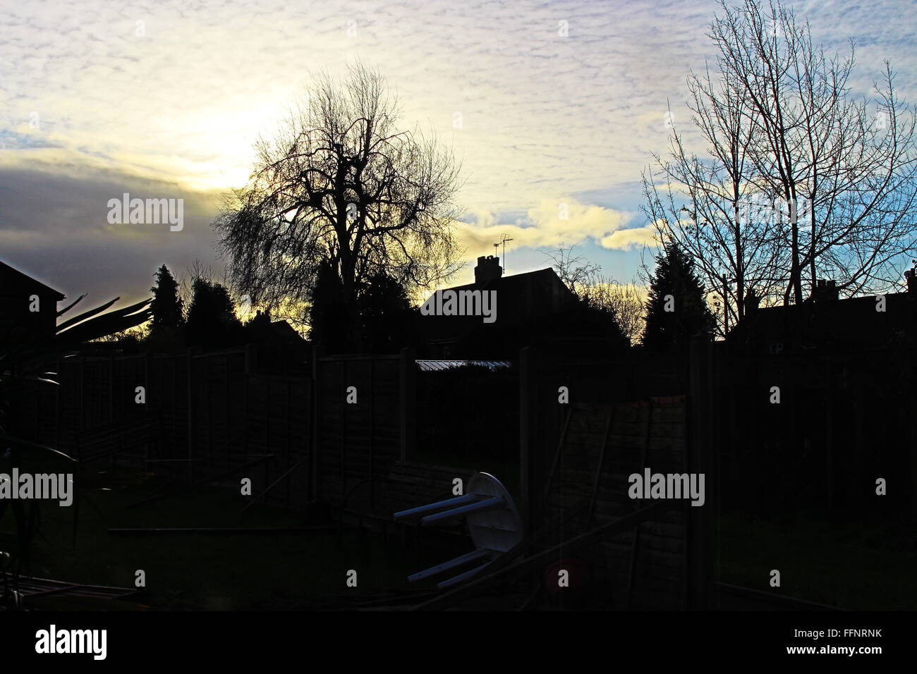 sunset over village Stock Photo - Alamy