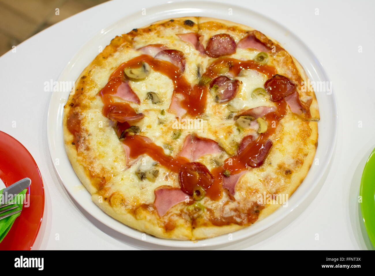 small pizza with a heart drawn with ketchup on a plate Stock Photo - Alamy
