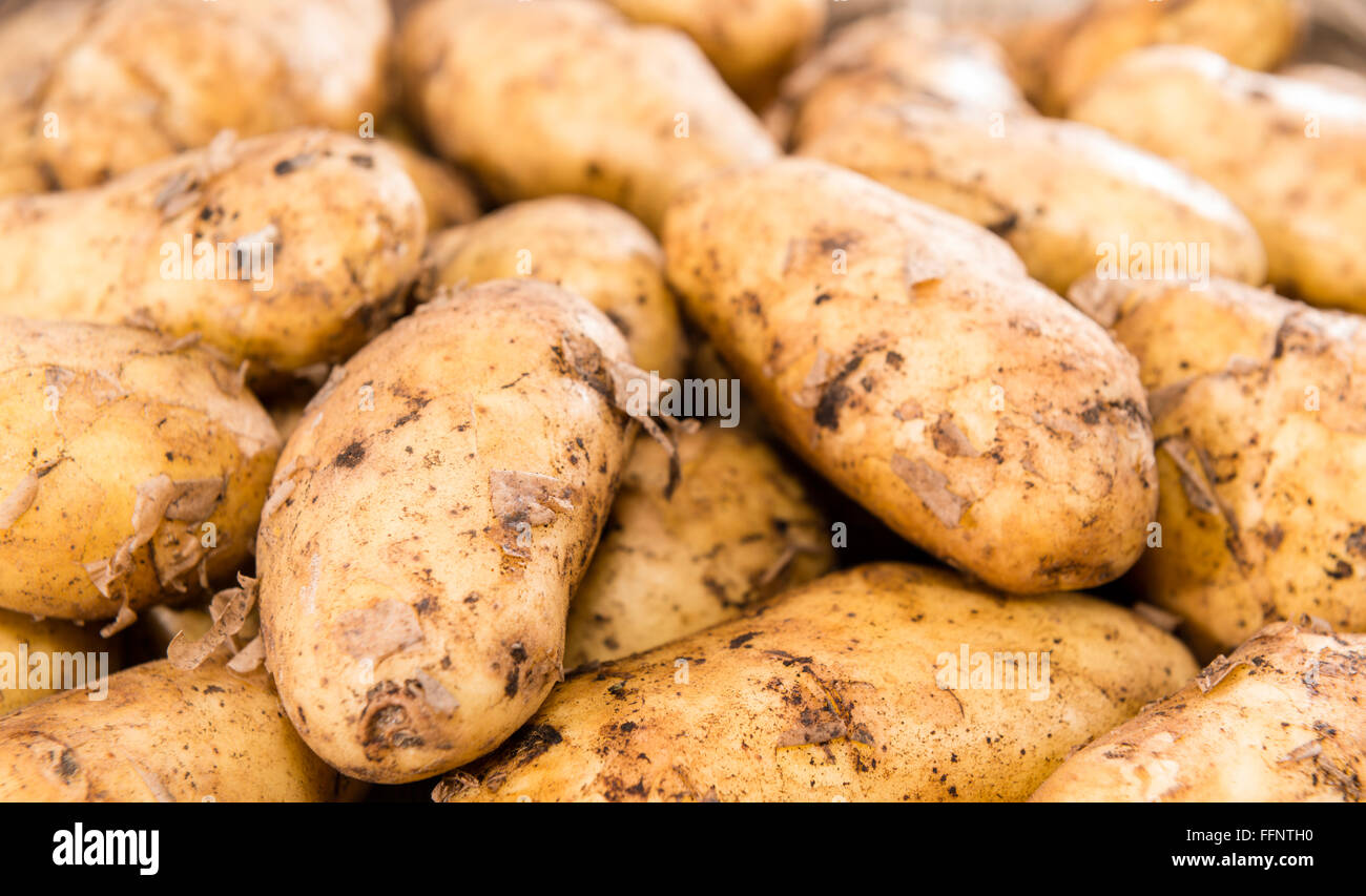 Portion of fresh Potatoes on vintage background Stock Photo - Alamy
