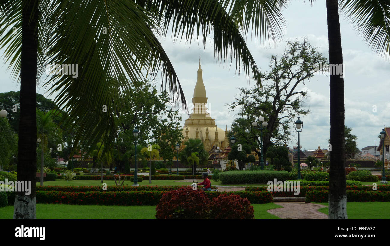 View through trees of Great Stupa in Vientiane, Laos Stock Photo - Alamy