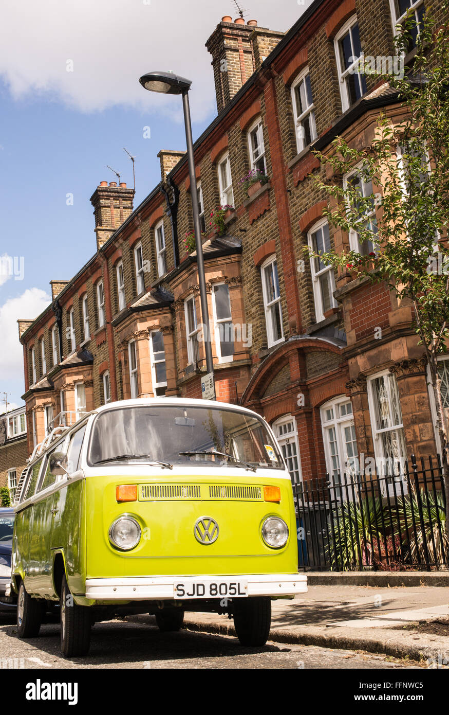 Old vintage green van parked in a street with Victorian houses in the ...
