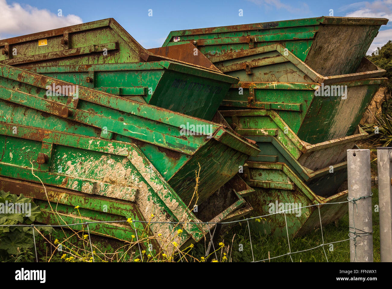 a stack of green skips Stock Photo - Alamy