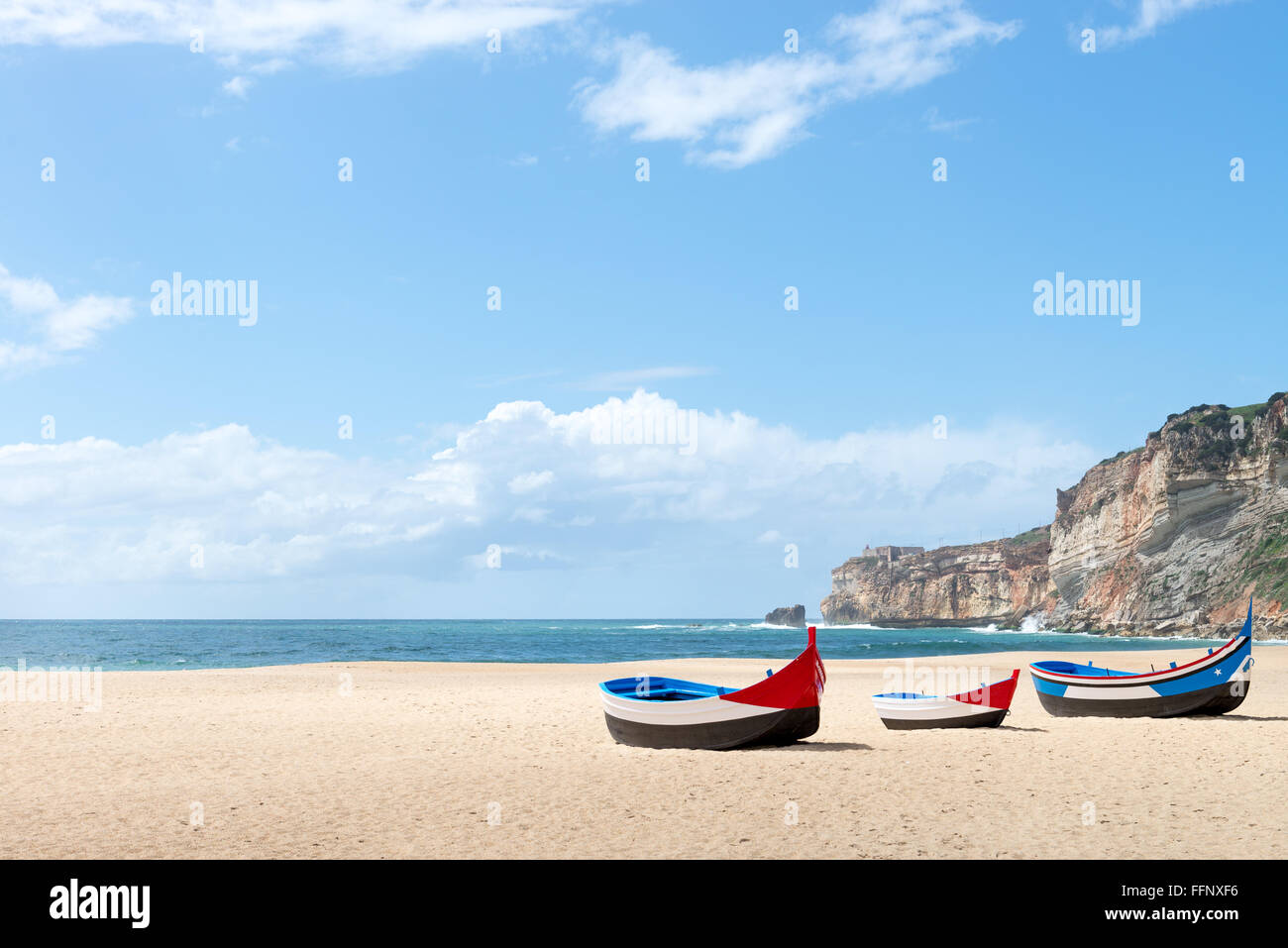 Main beach in Nazare with Traditional colorful boat on the sand ...
