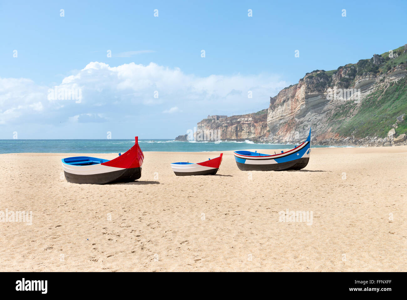 Main beach in Nazare with Traditional colorful boat on the sand ...