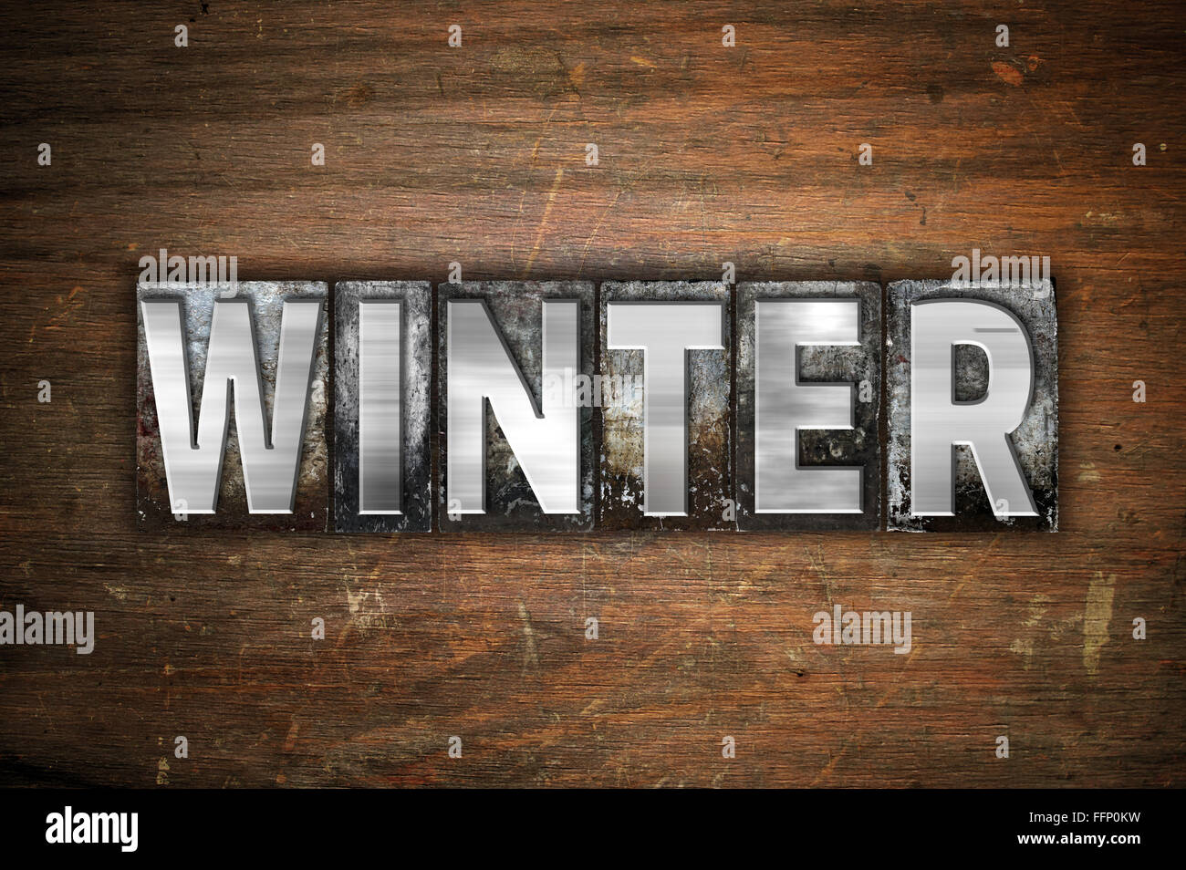 The word "Winter" written in vintage metal letterpress type on an aged ...