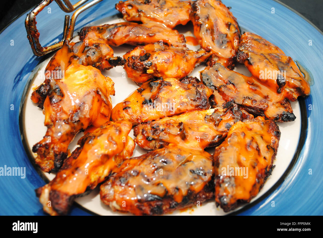 Spicy Chicken Wings on a Blue and White Plate Stock Photo - Alamy