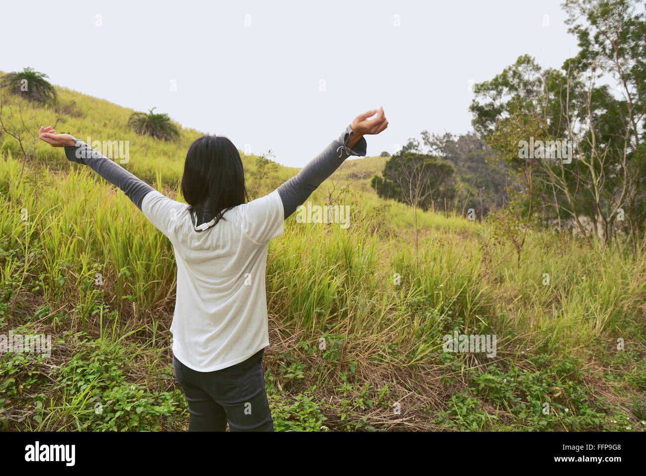woman standing with hands up. Future / freedom / hope / success concept ...