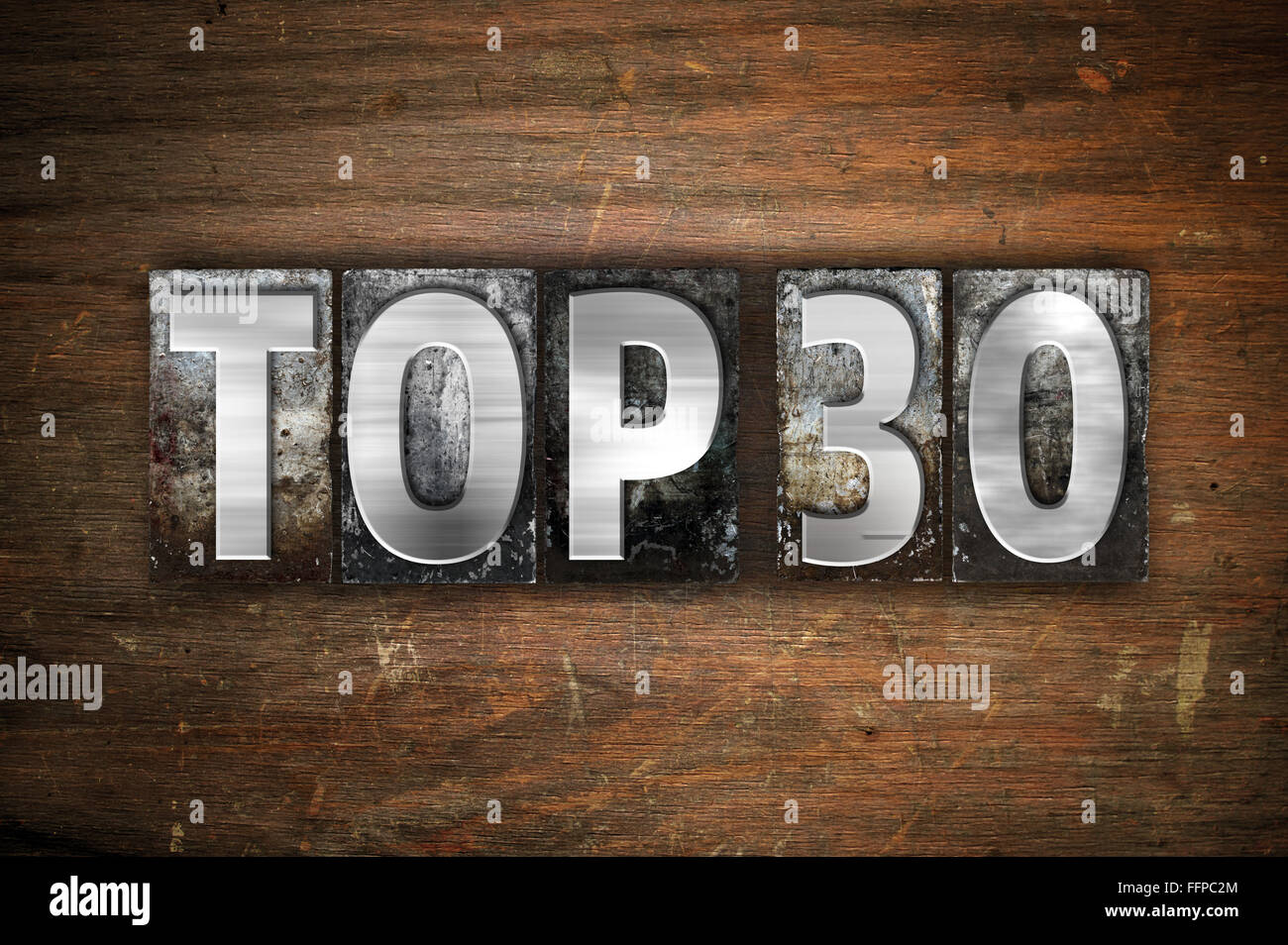 The word "Top 30" written in vintage metal letterpress type on an aged ...