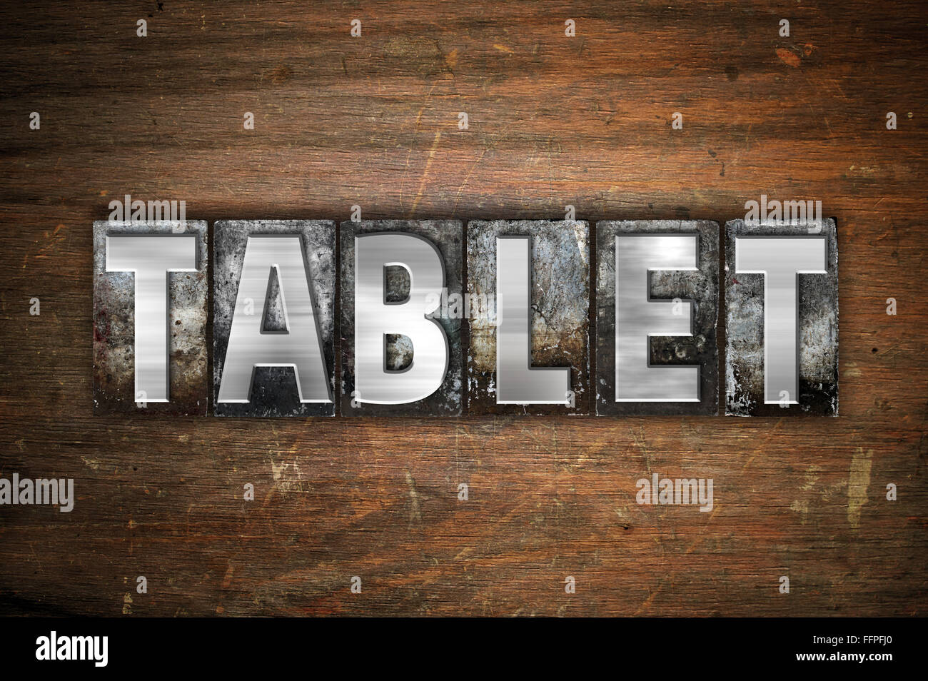 The word "Tablet" written in vintage metal letterpress type on an aged ...