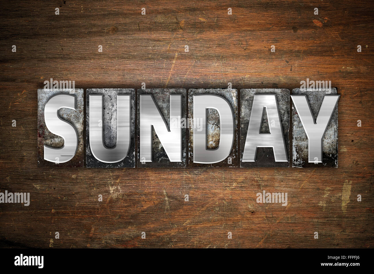 The word "Sunday" written in vintage metal letterpress type on an aged ...