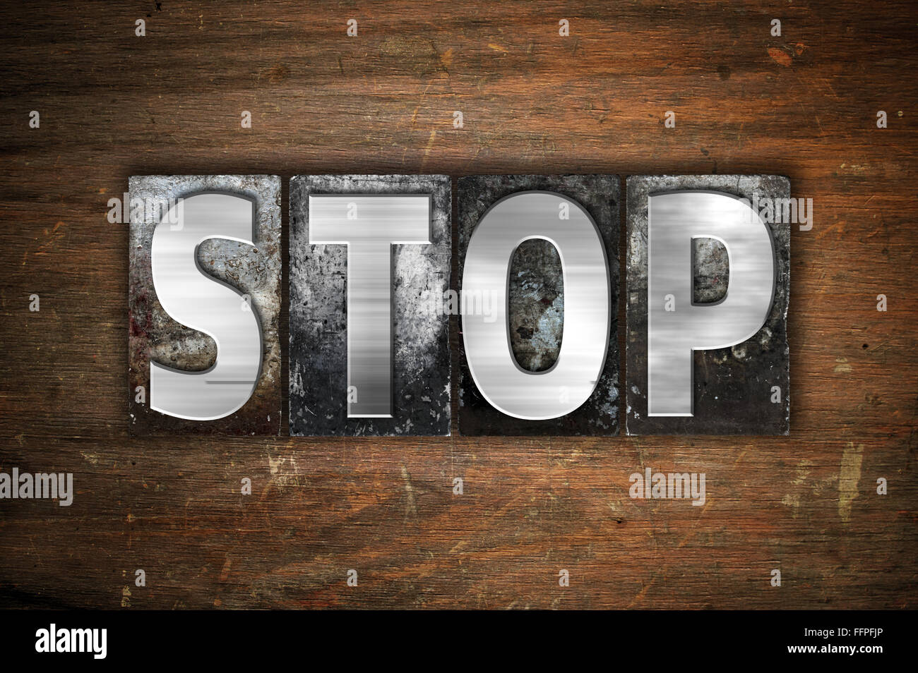 The word "Stop" written in vintage metal letterpress type on an aged ...