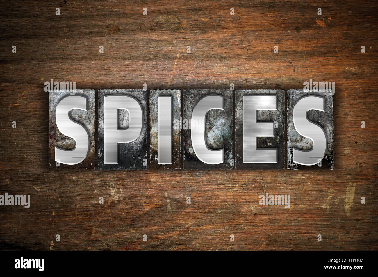 The word "Spices" written in vintage metal letterpress type on an aged ...