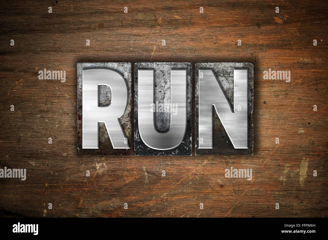 The word "Run" written in vintage metal letterpress type on an aged ...