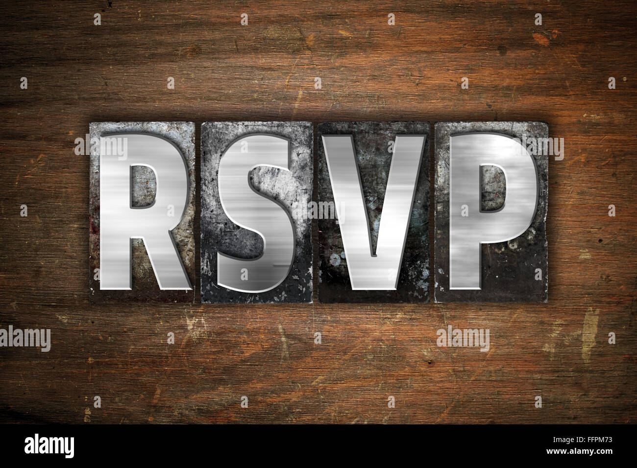 The word "RSVP" written in vintage metal letterpress type on an aged ...