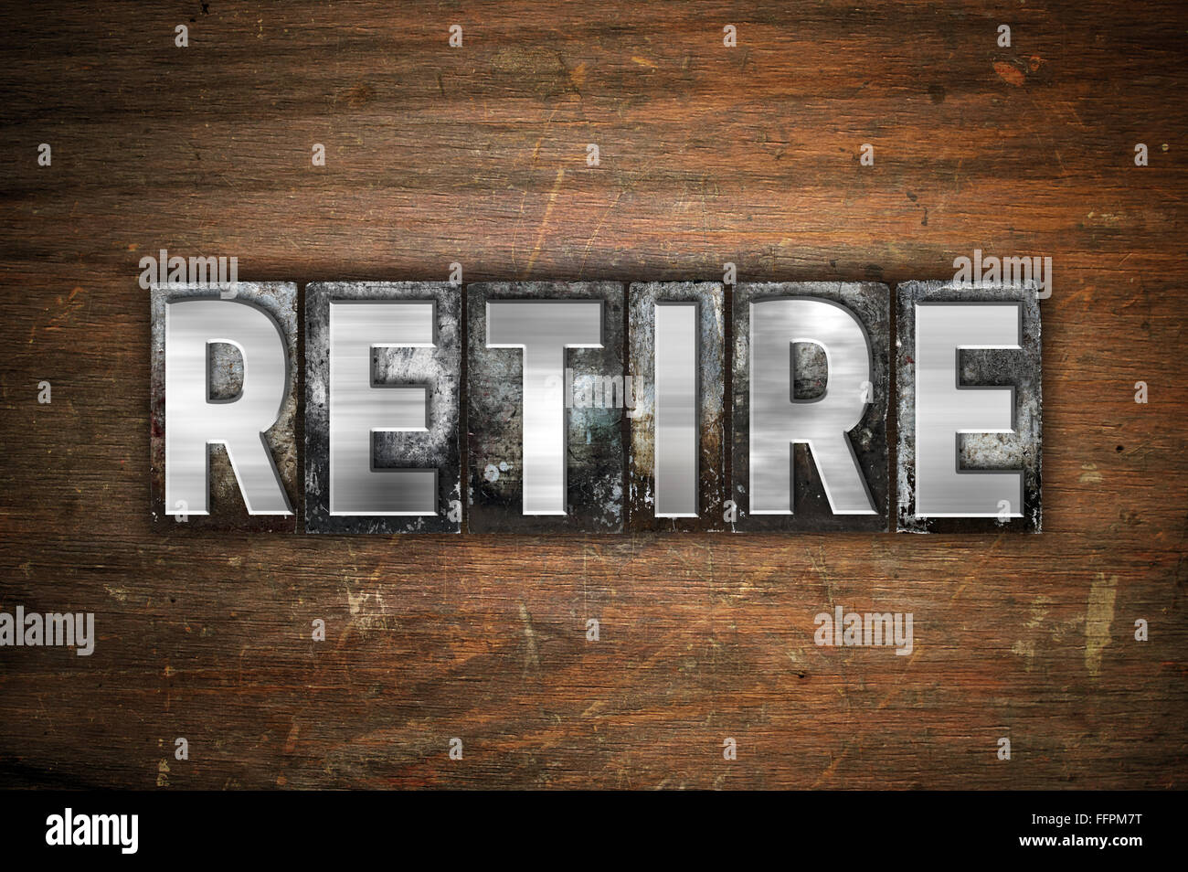 The word "Retire" written in vintage metal letterpress type on an aged ...