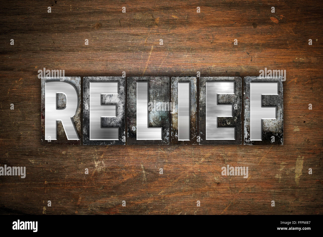 The word "Relief" written in vintage metal letterpress type on an aged ...