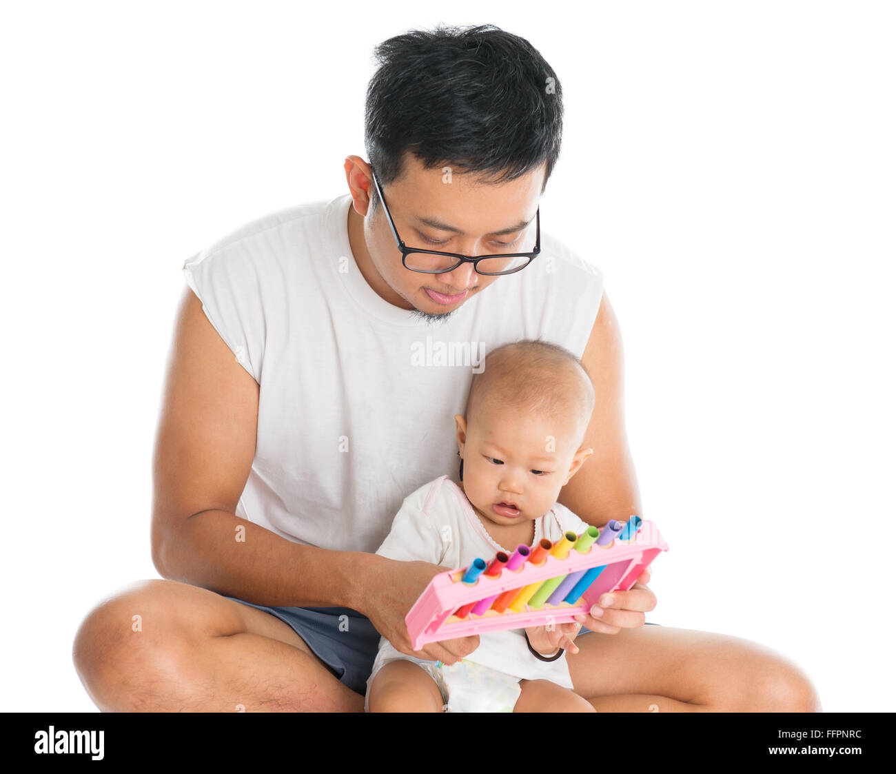 Father and baby playing music instrument. Sound development concept ...