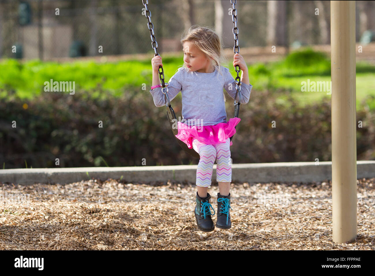 A Swinging Day At The Park Stock Photo - Alamy