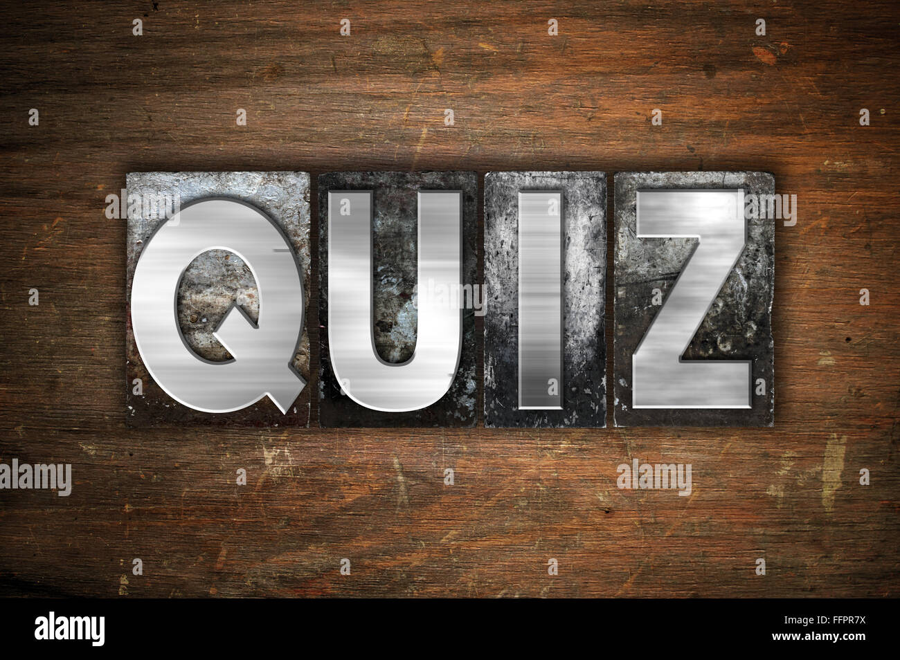 The word "Quiz" written in vintage metal letterpress type on an aged ...