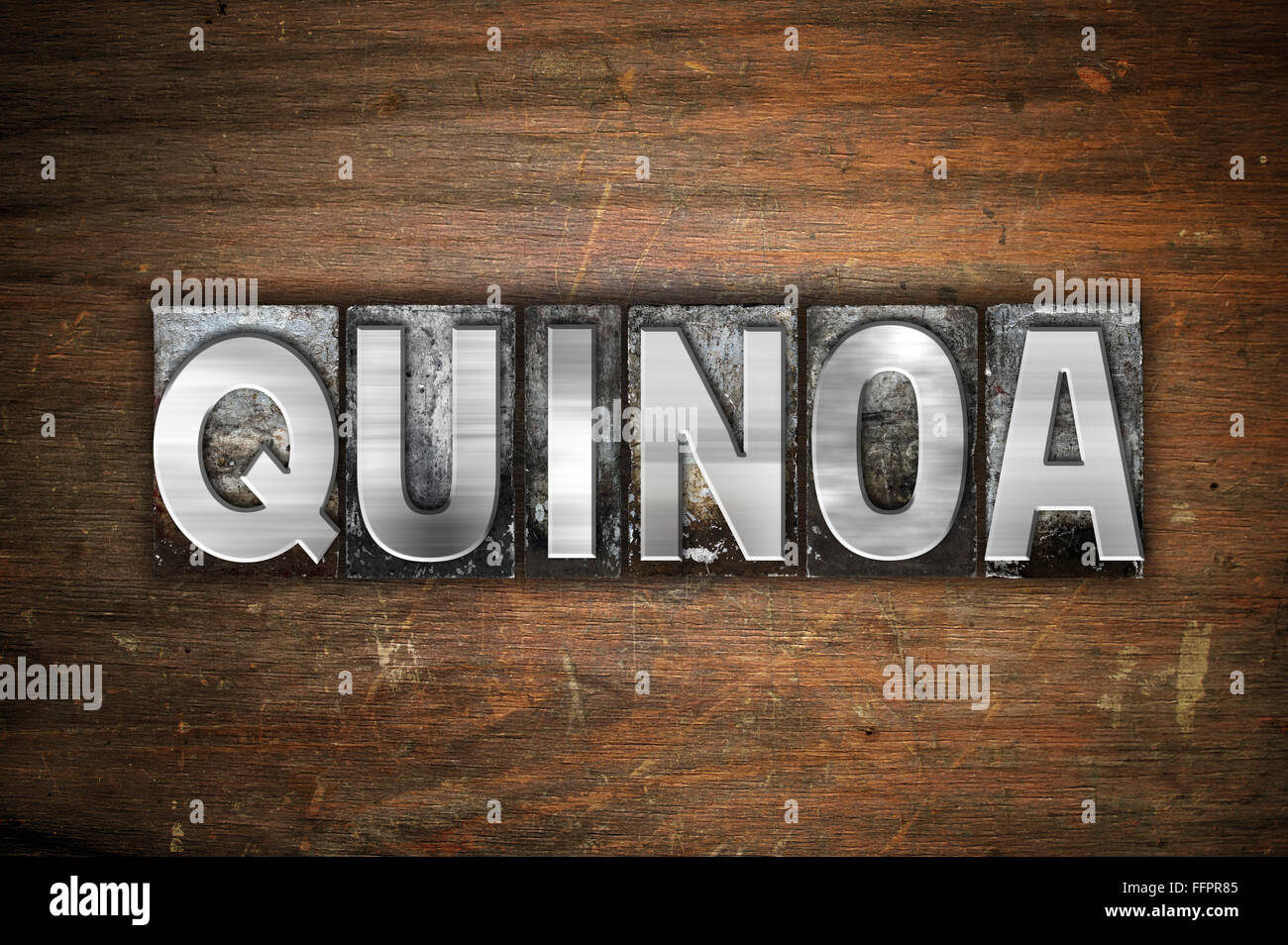 The word "Quinoa" written in vintage metal letterpress type on an aged ...